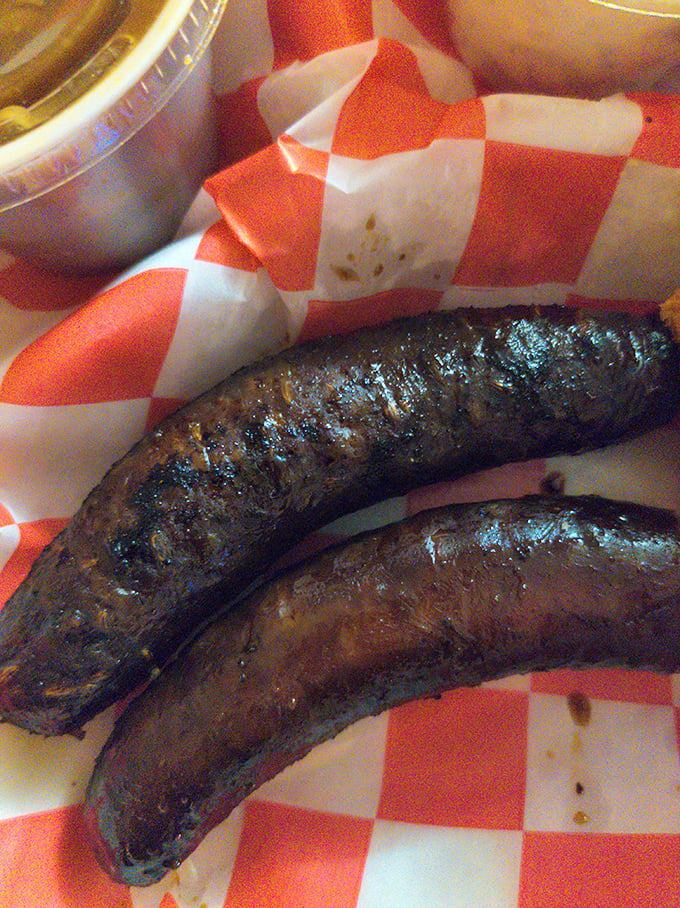 These sausages have the kind of snap that makes grown adults giggle with delight. Smoke-kissed perfection on a checkered paper.