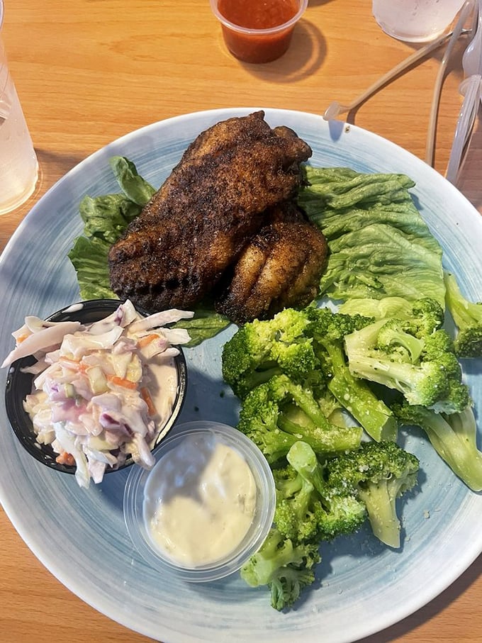 Blackened grouper with a side of broccoli and slaw—proof that sometimes the healthier option is also the most satisfying. That seasoning crust deserves its own fan club.