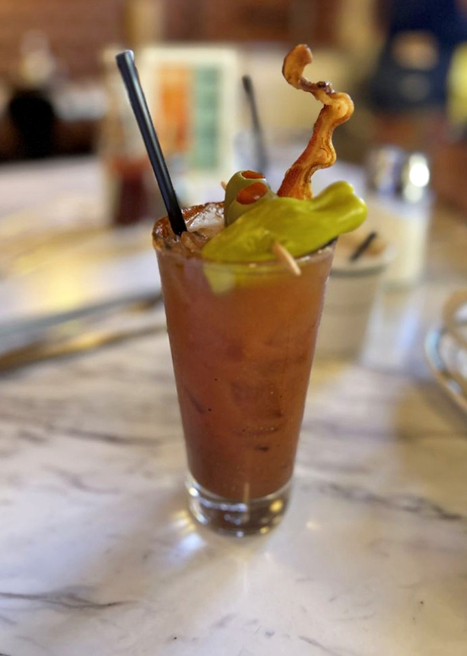 This Bloody Mary isn't just a drink—it's a meal with a kick. That bacon garnish is doing a victory lap around the glass.