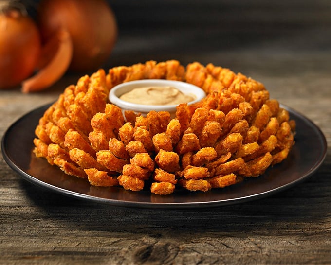 The legendary Bloomin' Onion—a golden-brown flower of crispy petals that's sparked more dinner table joy than most conversation topics ever could.