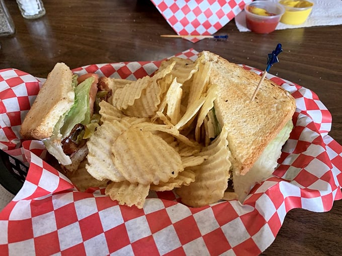 A sandwich that understands the importance of proper architecture – sturdy bread, generous fillings, and those ridged chips standing guard.