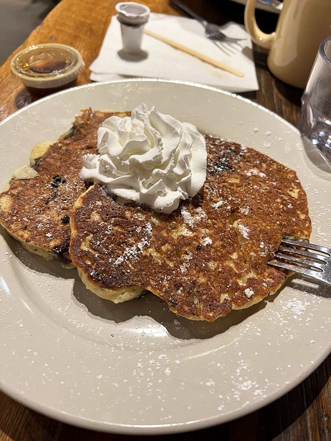 Plot twist: these aren't pancakes at your average diner—they're blueberry ricotta pancakes with a dollop of whipped cream that screams "breakfast of champions."
