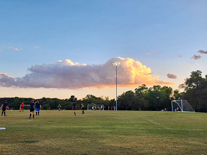 Evening soccer under dramatic Texas clouds—Boerne's community parks host everything from Little League championships to impromptu family picnics.