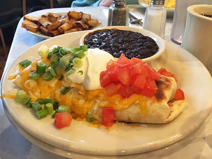 The breakfast burrito—where cheese, eggs, beans, and fresh toppings come together in a tortilla embrace that makes Monday mornings bearable again.