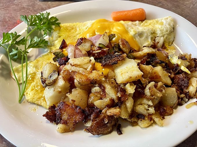 Breakfast artistry at its finest—crispy potatoes, fluffy eggs, and that perfectly placed parsley saying, "Yes, this is actually gourmet."