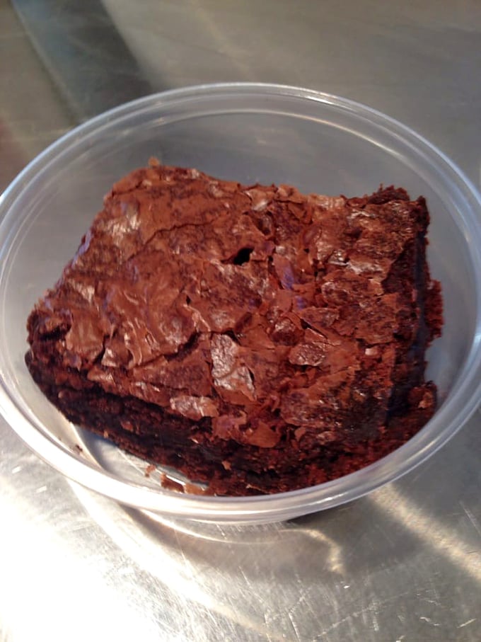 A brownie so dense and fudgy it could have its own gravitational pull. This isn't dessert—it's chocolate architecture.