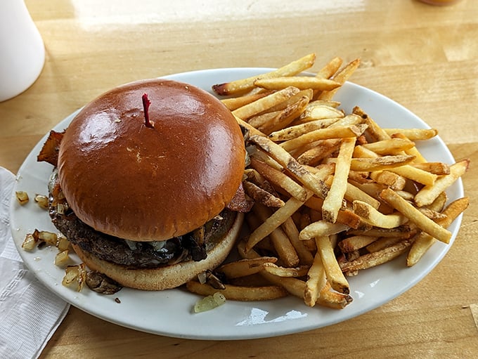 A proper diner burger should require both hands and extra napkins—this beauty with its glistening bun and mountain of fries doesn't disappoint.