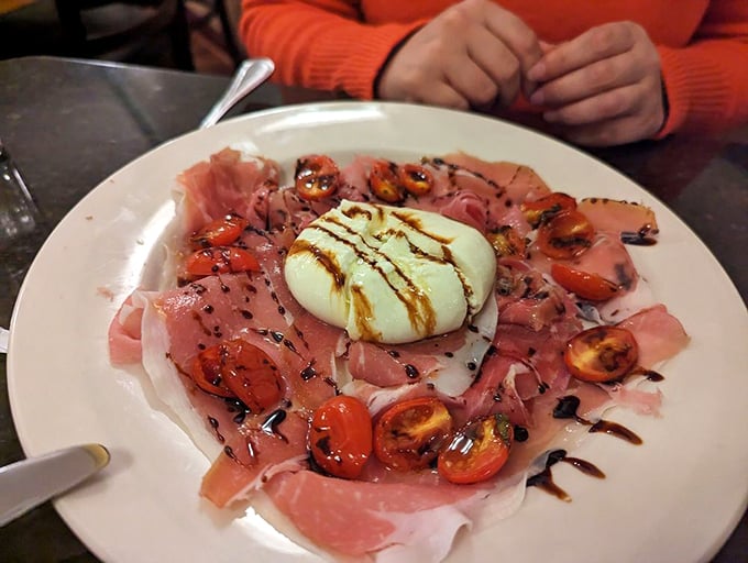 Burrata and prosciutto—Italy's power couple—sharing the spotlight with roasted tomatoes and a balsamic drizzle that ties everything together.