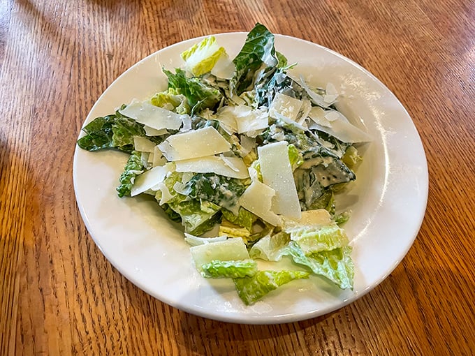 A Caesar salad that Julius himself would approve—crisp romaine, generous Parmesan shavings, and a dressing that achieves that perfect creamy-tangy balance.
