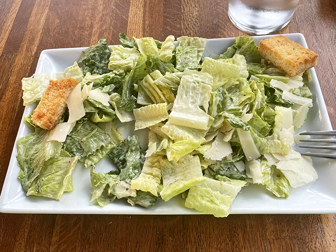 Even the Caesar salad gets the respect it deserves—crisp romaine, shaved parmesan, and house-made croutons that could convert a committed carnivore.