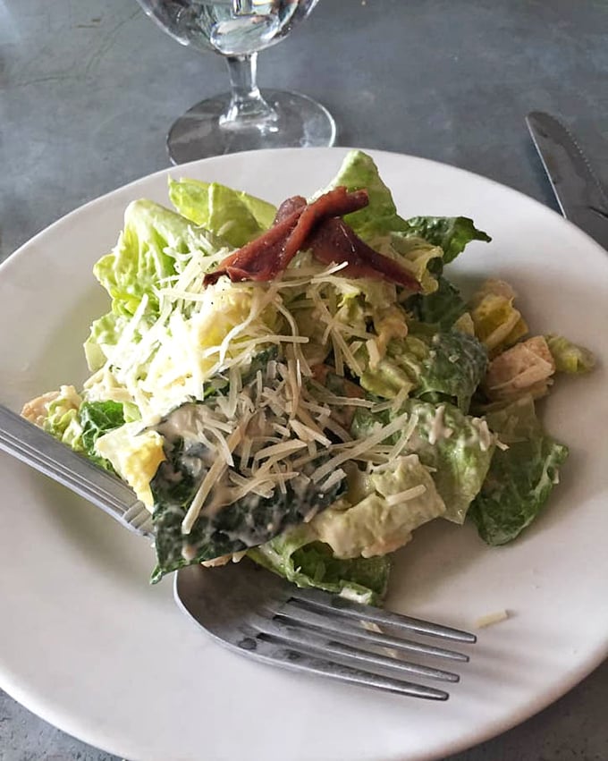 A Caesar salad that Julius himself would approve—crisp romaine, proper dressing, and those little anchovy whispers that make it authentic.