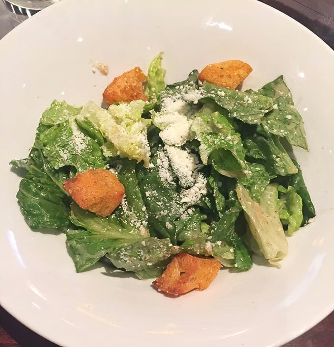 A Caesar salad that Julius himself would approve of—crisp romaine, house-made croutons, and just enough dressing to make each bite worth the inevitable cheese-in-teeth situation.
