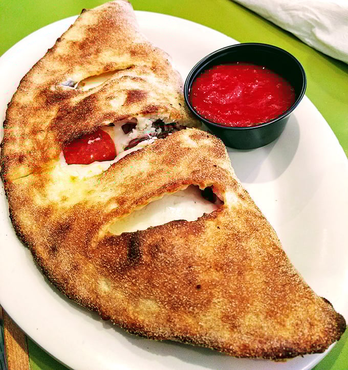 The calzone: pizza's mysterious, folded cousin who keeps all the good stuff hidden inside until that first, steam-releasing bite.