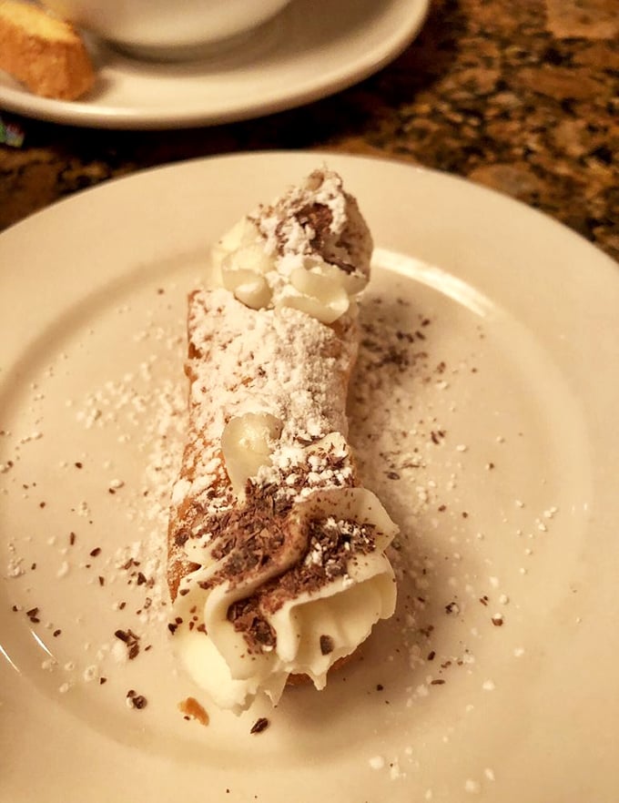 This cannoli isn't just dessert—it's edible architecture with a creamy filling that makes people forget their table manners and lick the plate.