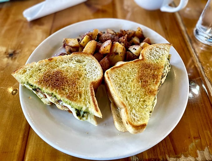Two perfectly grilled triangles of bread hide a melty Caprese secret—fresh mozzarella, ripe tomatoes, and basil proving that the humble sandwich can indeed achieve greatness.