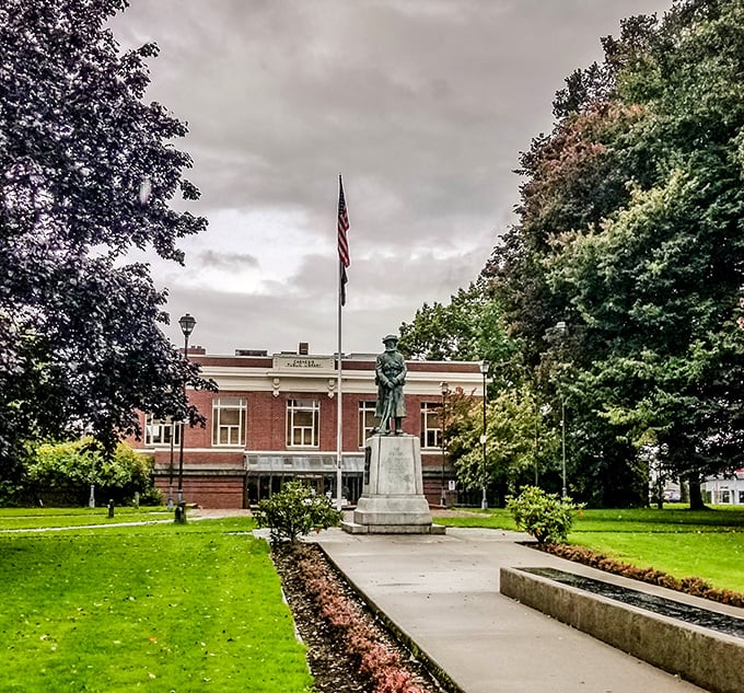 The Centralia Timberland Library stands proudly with its statue sentinel, a brick-and-mortar reminder that knowledge remains our most valuable community resource.