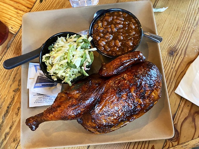 Half chicken gleaming with lacquered bark, coleslaw for crunch, and beans that have clearly been simmering with purpose and pork.