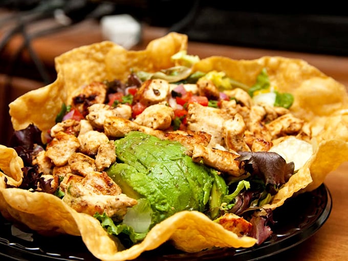 When salad goes to Hollywood – crispy tortilla bowl cradles fresh greens and grilled chicken in a healthy-ish California compromise.
