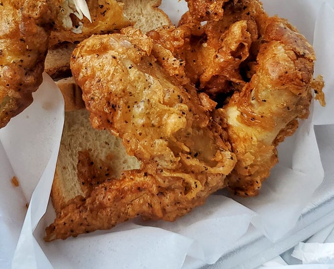 Crispy, seasoned chicken wings nestled beside golden cornbread. Some food photographers use tricks to make food look good—this chicken just naturally poses for greatness.