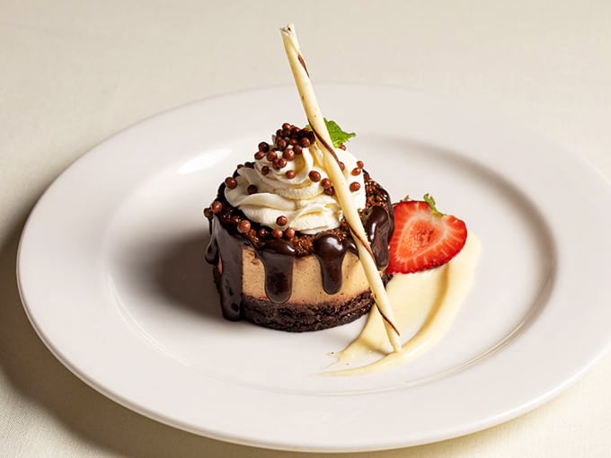The Chocolate Peanut Butter Bomb defies gravity and good sense – a dessert so perfectly composed it belongs in both a museum and your immediate future.