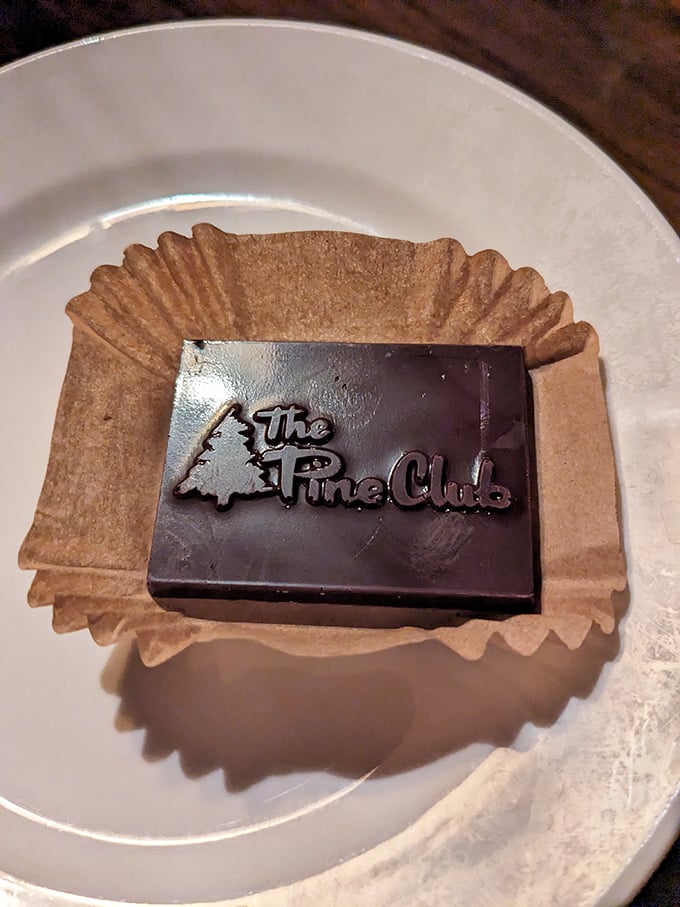 The Pine Club's chocolate finale – because after conquering a steak dinner, you deserve a sweet victory lap emblazoned with their logo.