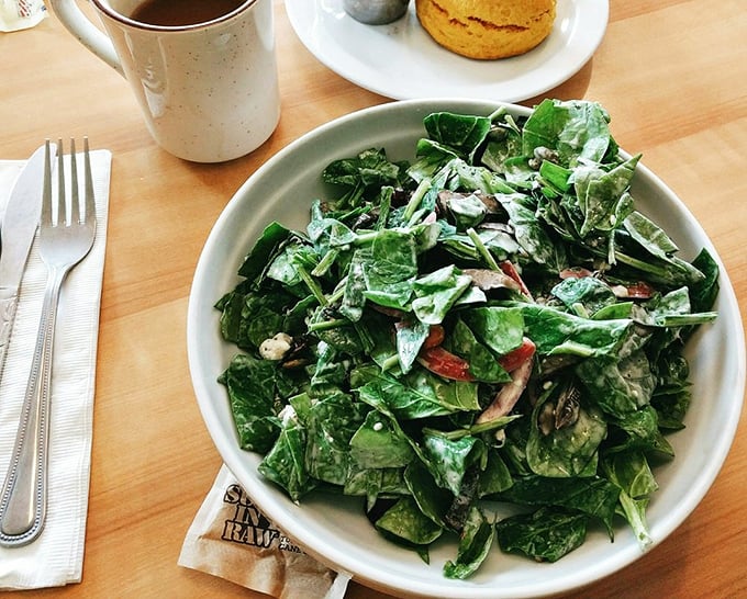 Even the salad looks like it's having more fun than most of us—fresh greens tossed with enough goodies to make you forget you ordered "healthy."