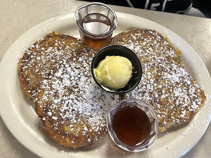 These pancakes aren't just breakfast, they're an event—golden, fluffy, and dusted with powdered sugar that melts into the butter and syrup.