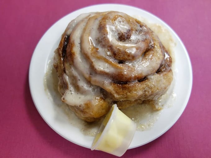 This cinnamon roll isn't just breakfast—it's an event, a spiral of cinnamon-sugar joy crowned with a melting pat of butter.