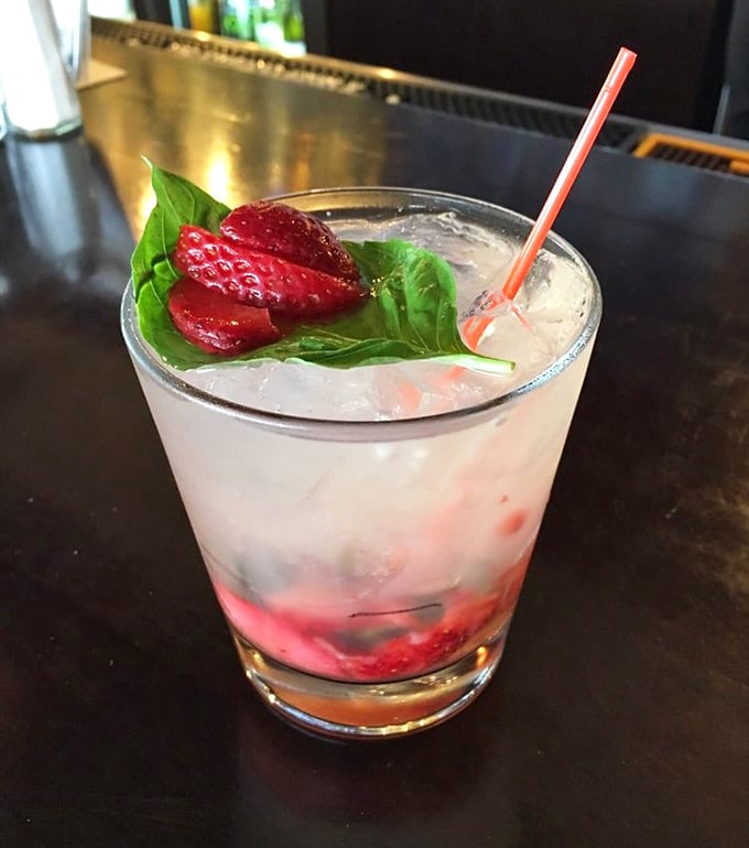 A cocktail that looks like Minnesota summer in a glass. That strawberry and basil garnish isn't just pretty – it's practically winking at you.