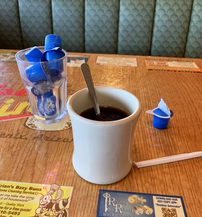 The coffee comes in mugs thick enough to withstand nuclear winter, served with those little blue creamers that somehow taste like childhood.