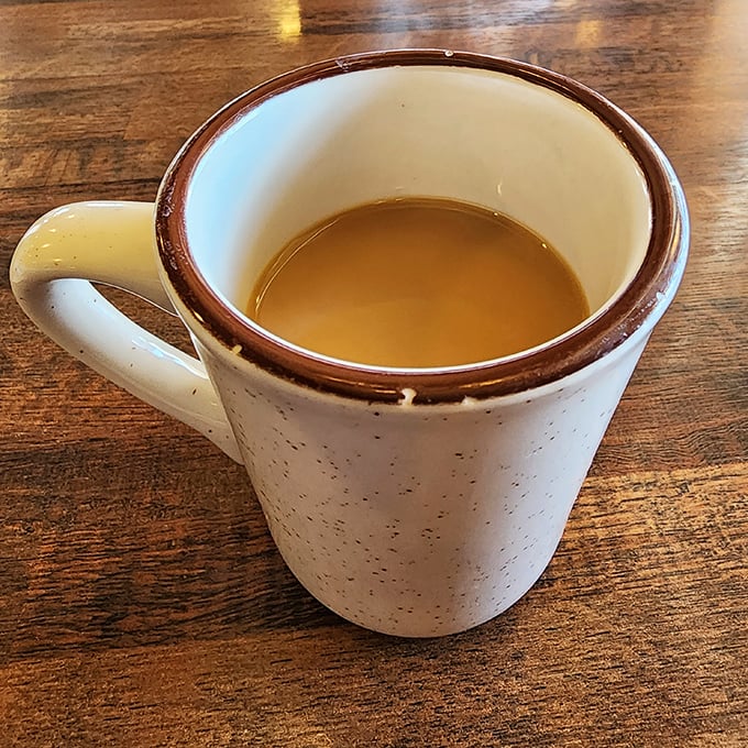 That coffee mug – thick-walled, no-nonsense – holds the lifeblood that's fueled Oklahoma conversations since statehood.