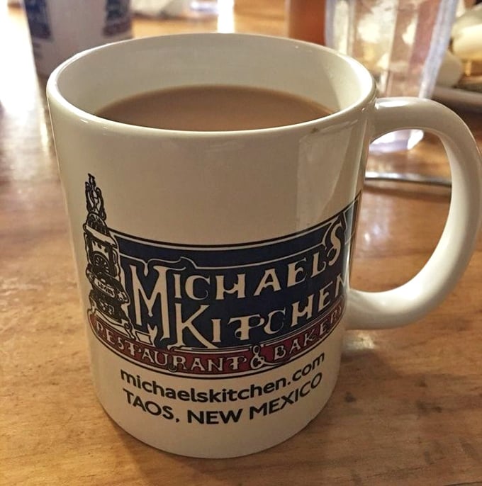A mug of coffee bearing the Michael's Kitchen logo – your trusty companion through a breakfast adventure that requires proper caffeination.