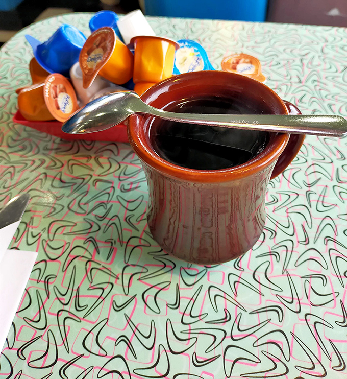 The coffee comes in mugs that feel like they've been in your hand forever. In diner language, a full cup is the universal sign for "you belong here."