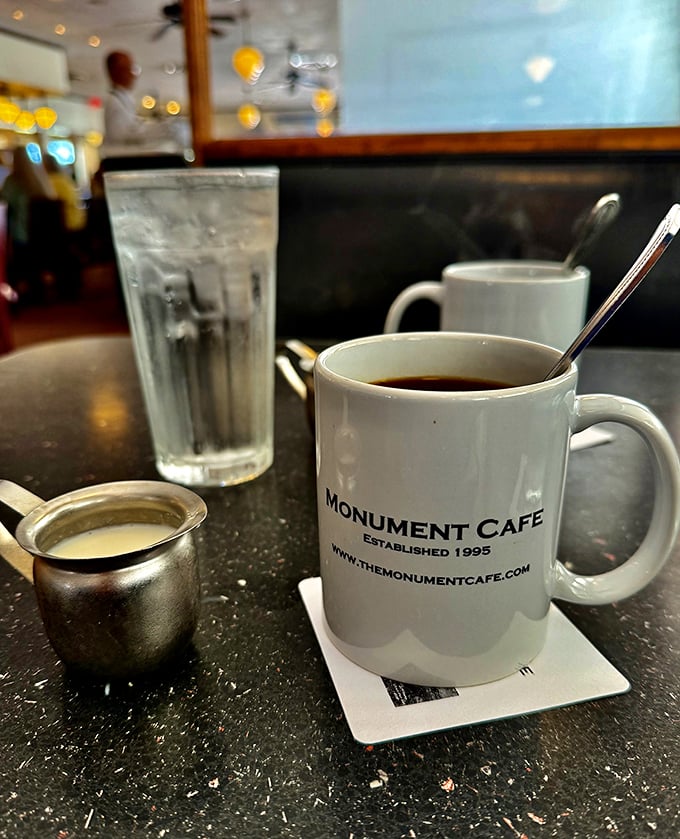 That classic white mug isn't just holding coffee—it's cradling liquid motivation that's been fueling Georgetown conversations since 1995.