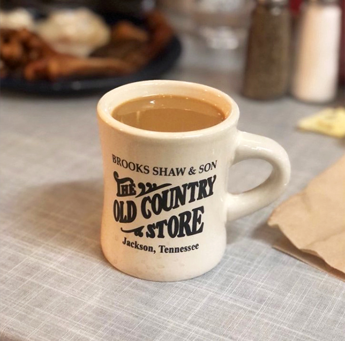 The sturdy diner mug—filled with coffee strong enough to wake the dead—bears the establishment's name like a badge of honor.