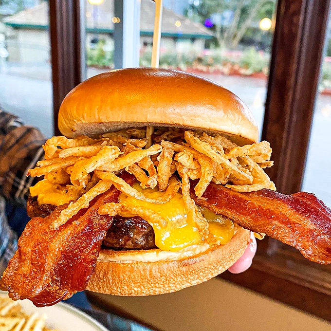 This isn't just a burger—it's architecture. Melty cheese cascading over bacon with crispy onion straws playing structural support.
