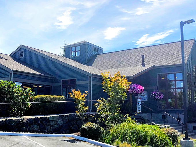 The blue-hued building with its welcoming entrance and vibrant landscaping isn't just a library – it's Coupeville's living room where stories are shared and discovered.