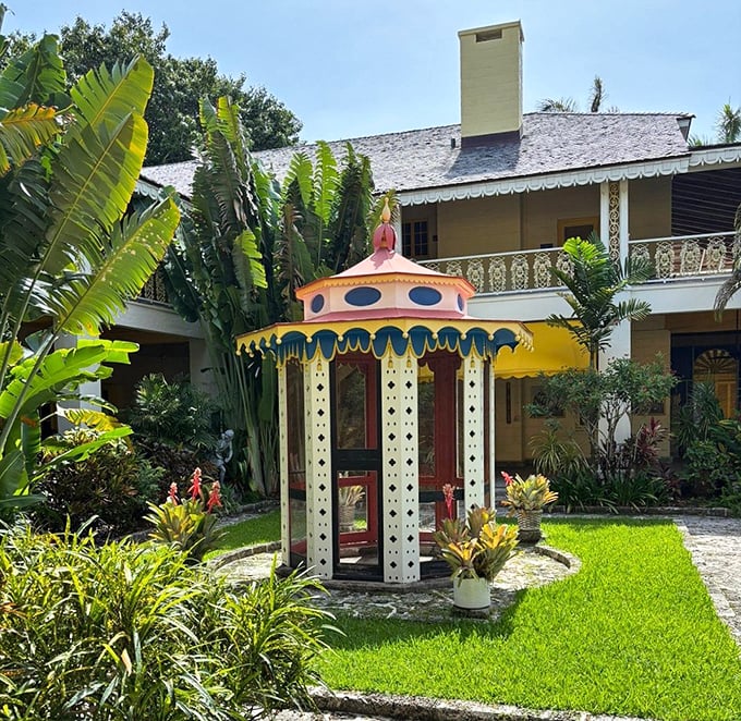 The carousel gazebo looks like it was plucked from a Wes Anderson film set, its candy-colored charm a delightful surprise amid the greenery.