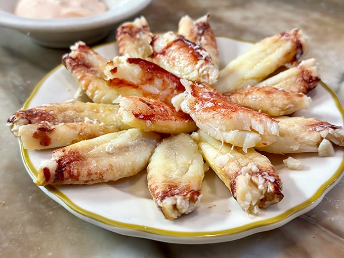 Crab legs arranged like nature's perfect fan – sweet, tender meat that makes you wonder why we bother cooking anything else in this world.