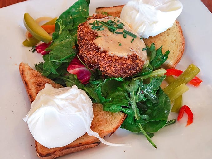 This isn't just a crab cake—it's an island of crispy-tender seafood perfection in a sea of fresh greens and poached egg pearls.