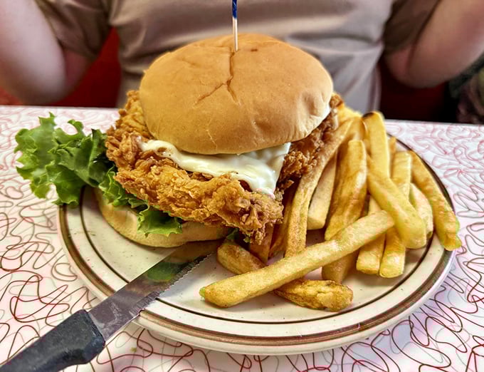 This isn't just a sandwich; it's architecture—a golden-fried chicken masterpiece supported by fresh lettuce and a perfectly toasted bun.