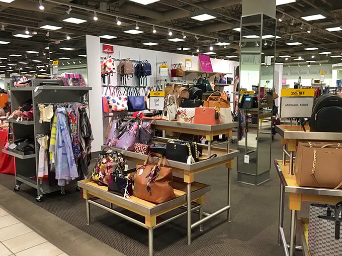 Not just a store, but a museum of possibility – Michael Kors handbags arranged with the precision of a high-stakes game of Tetris.