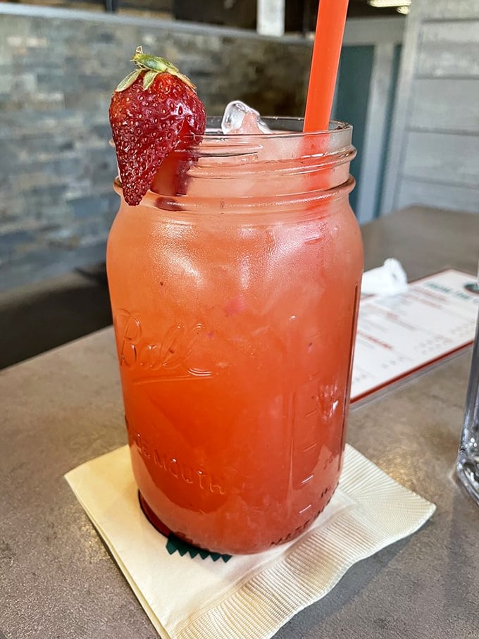 This isn't just a strawberry drink—it's summer in a mason jar, the kind of refreshment that makes you forget you just devoured half a pig.