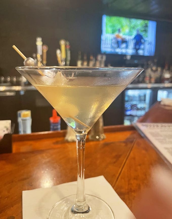 A perfectly chilled martini awaits at the bar – because sometimes the best appetizer is liquid courage before tackling a 24-ounce steak.