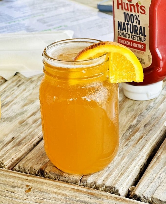 Sweet tea served in a mason jar with an orange slice – the unofficial champagne of the South and perfect companion to seafood.