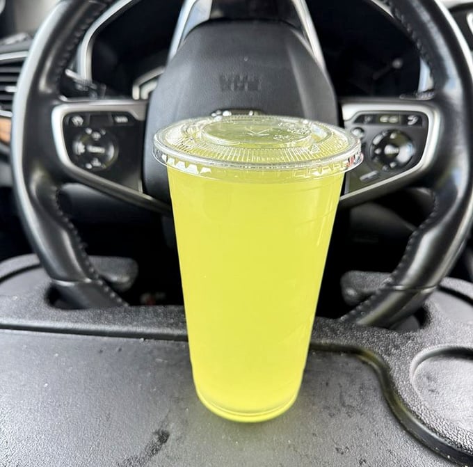 That neon yellow drink isn't just refreshing—it's practically radiating happiness from the cup holder of someone's very lucky day.