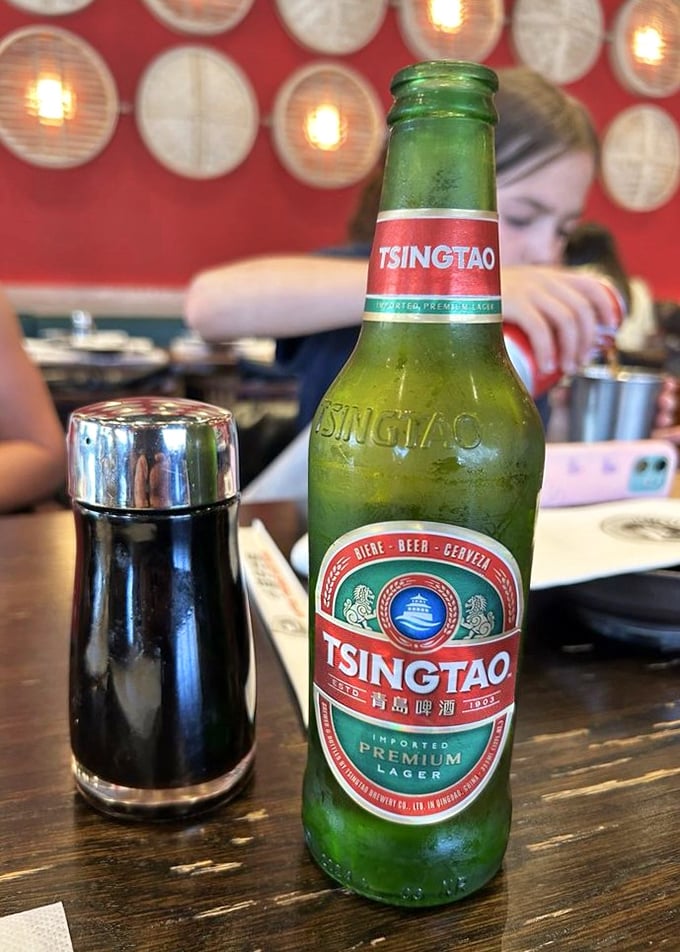 A cold Tsingtao beer stands ready to cool the fire of spicy dishes – the international language of "ahh, that's better" in bottle form.