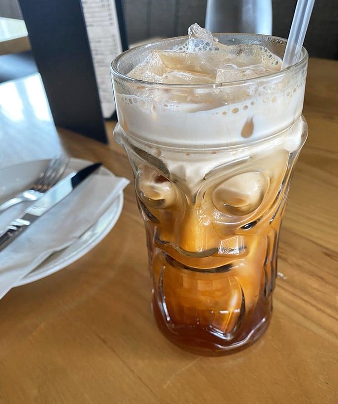 Thai iced tea served in a tiki glass – because sometimes your beverage deserves to wear a fun outfit while cooling down your spice-tingled taste buds.