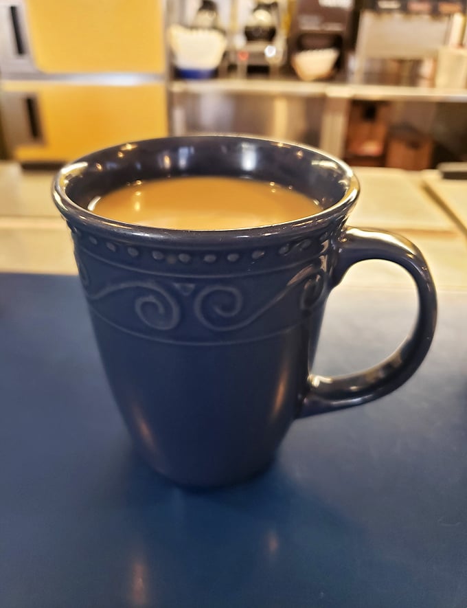 That blue mug of coffee sits ready to fuel whatever breakfast adventure you're about to embark upon this morning.