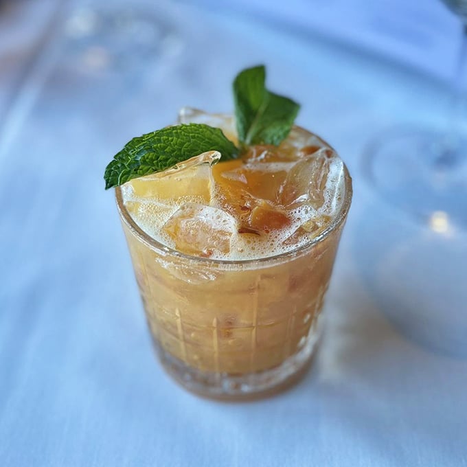 This isn't just a cocktail – it's liquid sunshine with mint and ice, the kind of drink that makes you forget about emails waiting in your inbox.